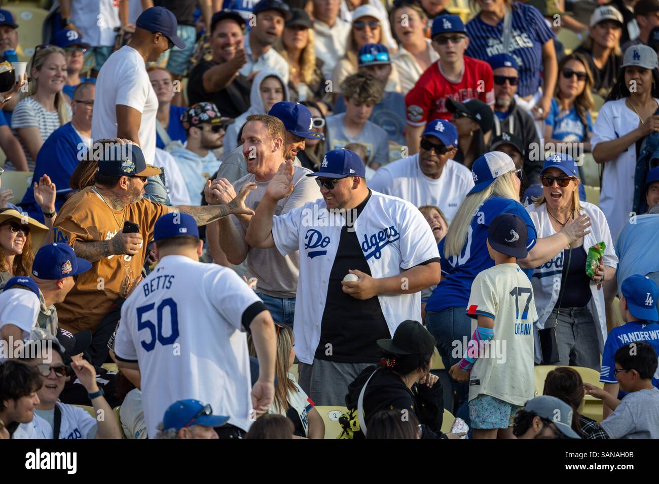 April 13, 2025: Dodger fans celebrate catching a foul ball during a ...