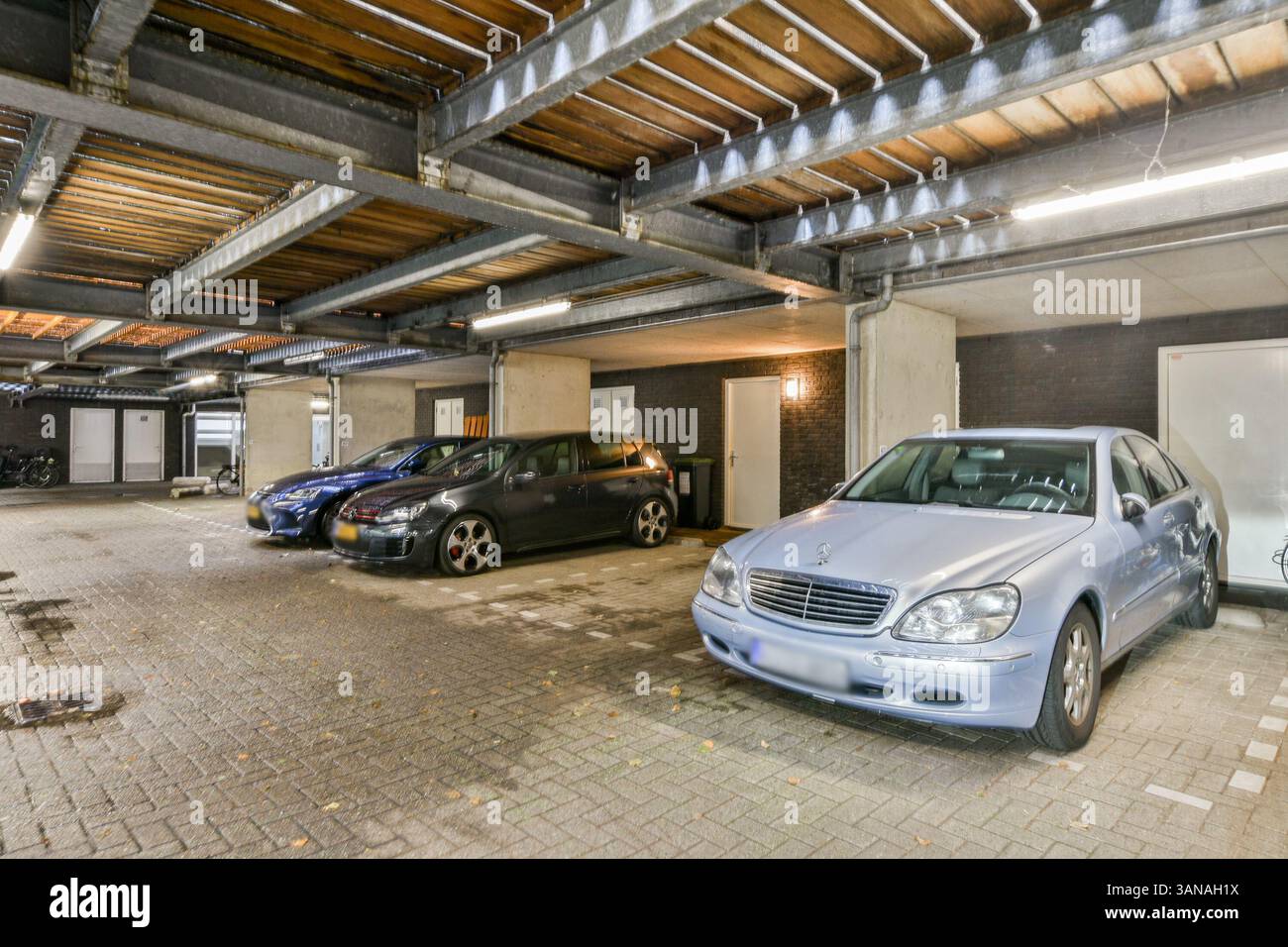 A contemporary underground parking area featuring multiple vehicles ...