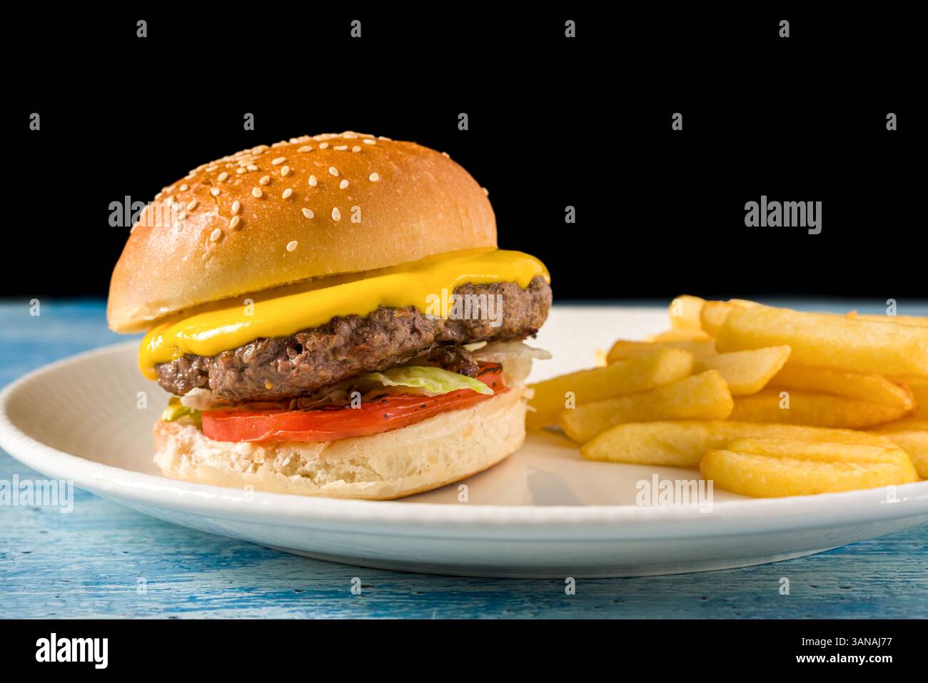 Smash burger with cheddar cheese and caramelized onions, served with ...