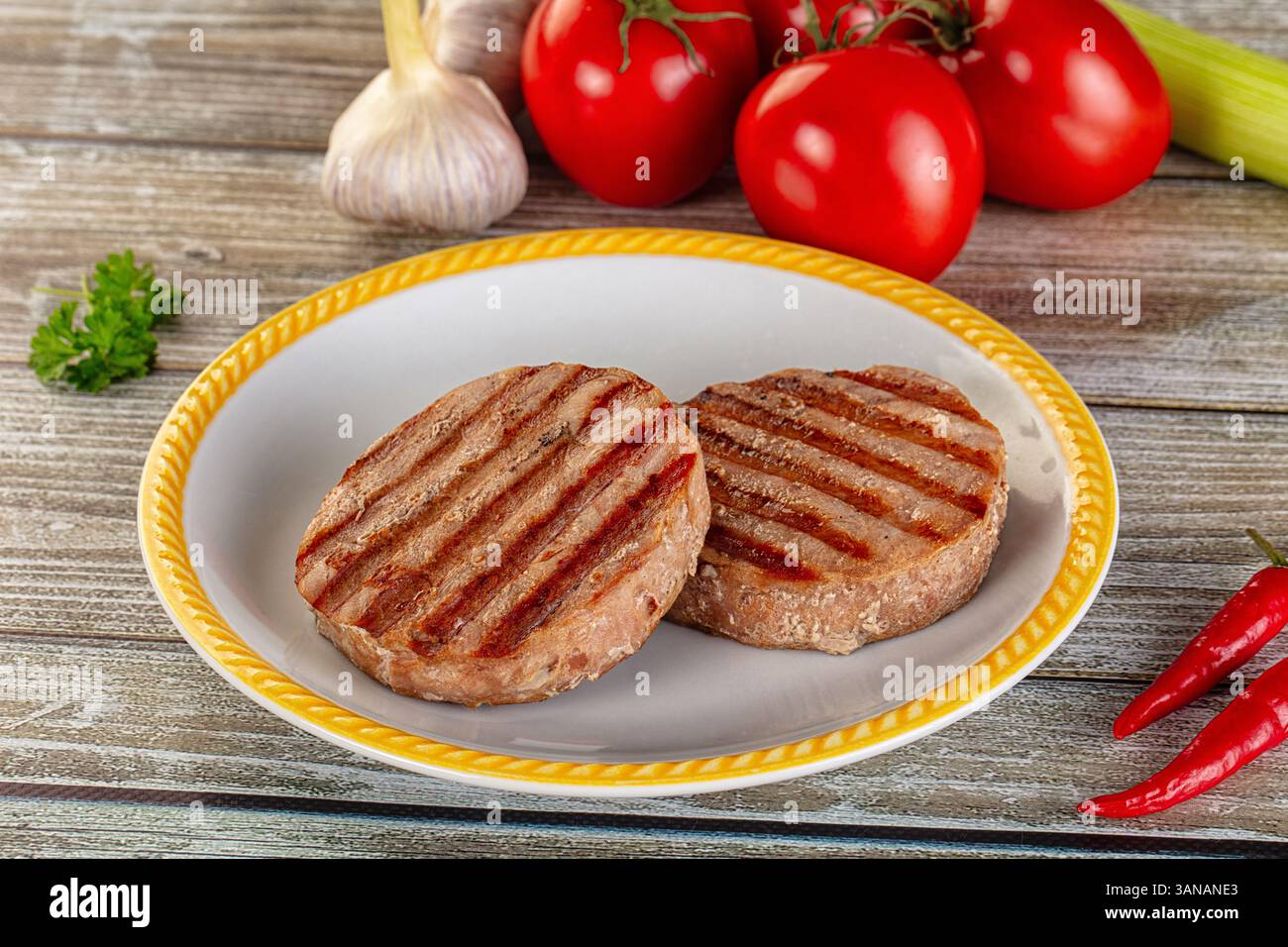 Grilled tuna steak fillet round medallion Stock Photo - Alamy