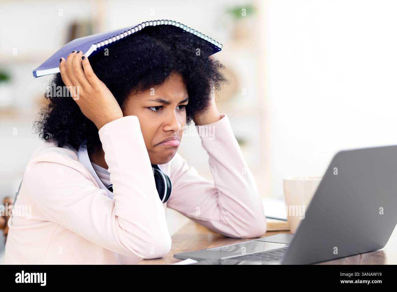 Sad Black Girl At Laptop Covering Head With Exercise-Book Indoor Stock ...