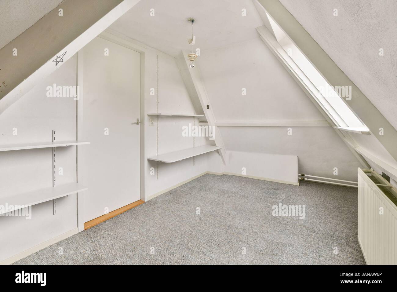 An airy room featuring a slanted roof, neutral walls, and simple ...