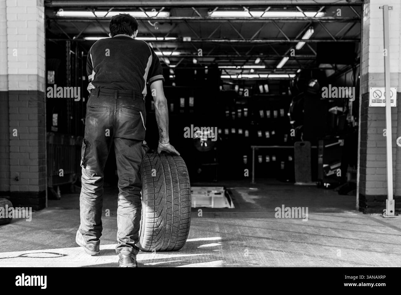 Tyre fitter Black and White Stock Photos & Images - Alamy