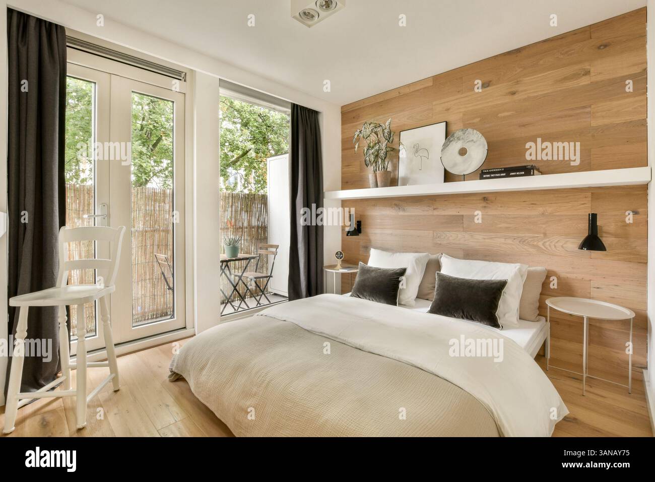 A stylish modern bedroom featuring a neutral color palette, wooden ...