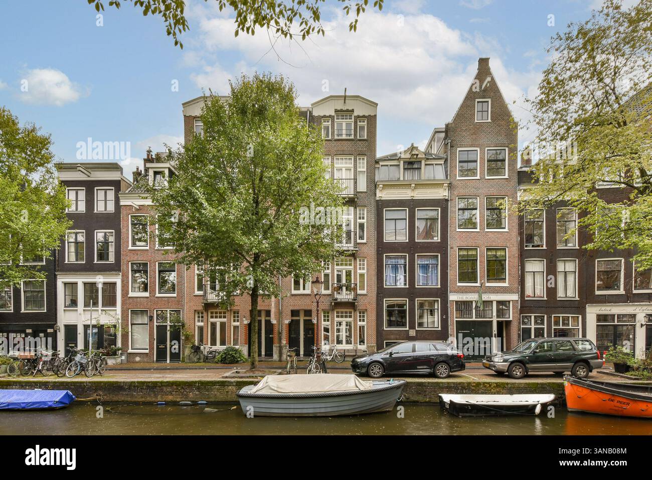 Quaint canal scene showcasing elegant architecture, flourishing trees ...