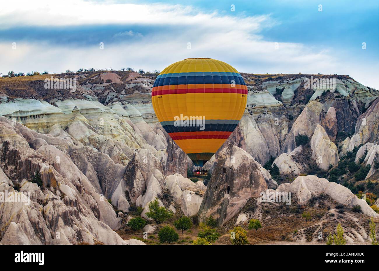 Colorful hot air balloons floating over Cappadocia, Turkey—unique rock ...