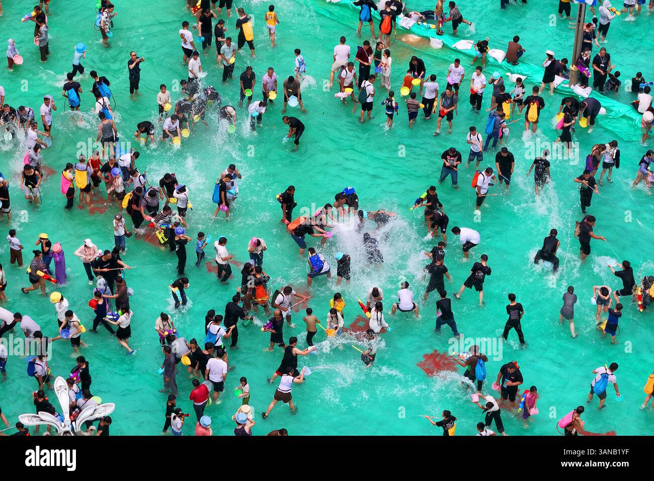 People take part in activities to celebrate the Water Splashing ...
