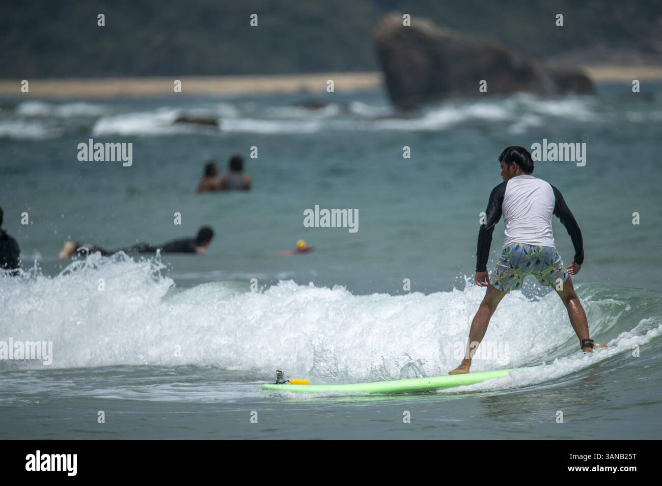 Tourists experience surfing at Riyue Bay in Wanning City, southernmost ...