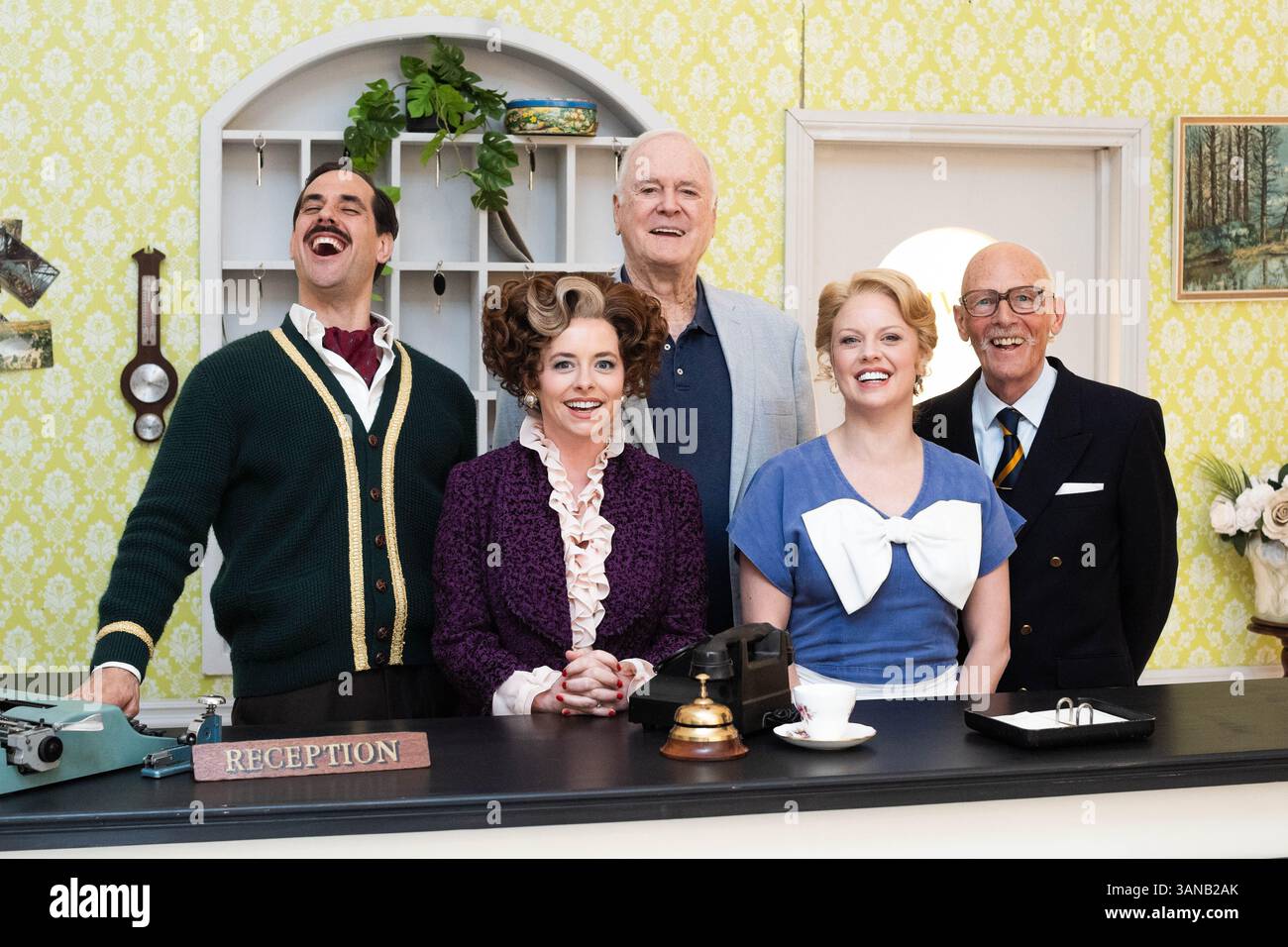 John Cleese (centre) with the cast of 'Fawlty Towers: The Play', (left ...