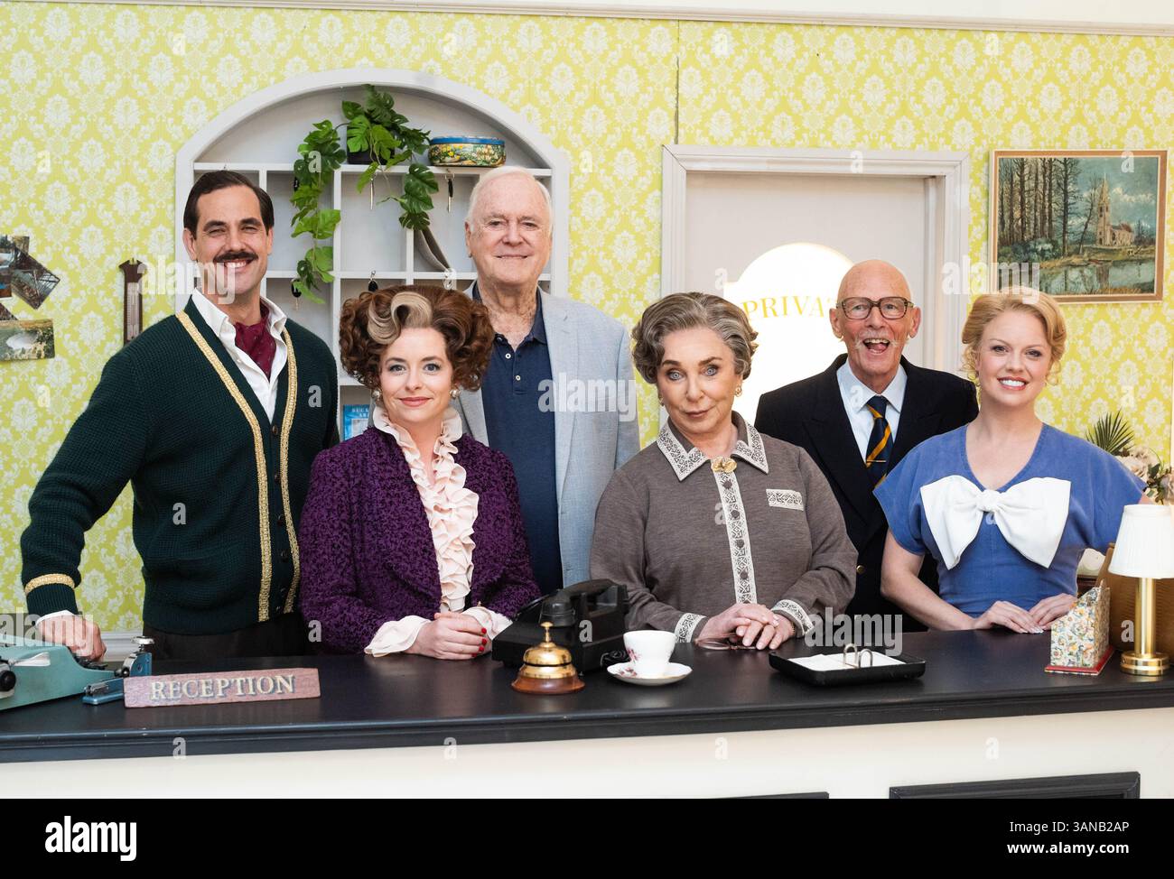 John Cleese (centre back) with the cast of 'Fawlty Towers: The Play ...