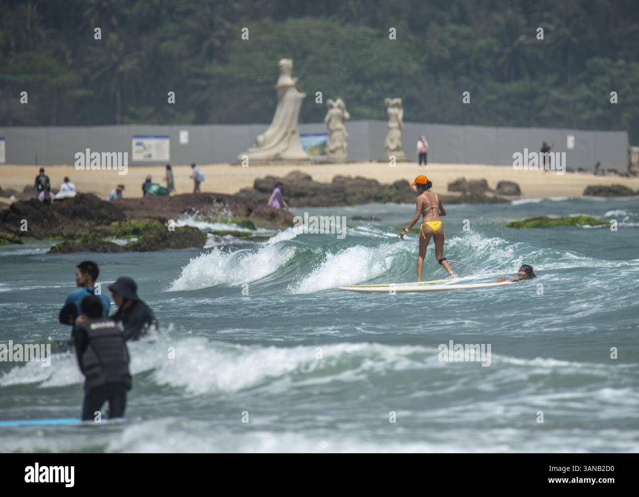 Tourists experience surfing at Riyue Bay in Wanning City, southernmost ...