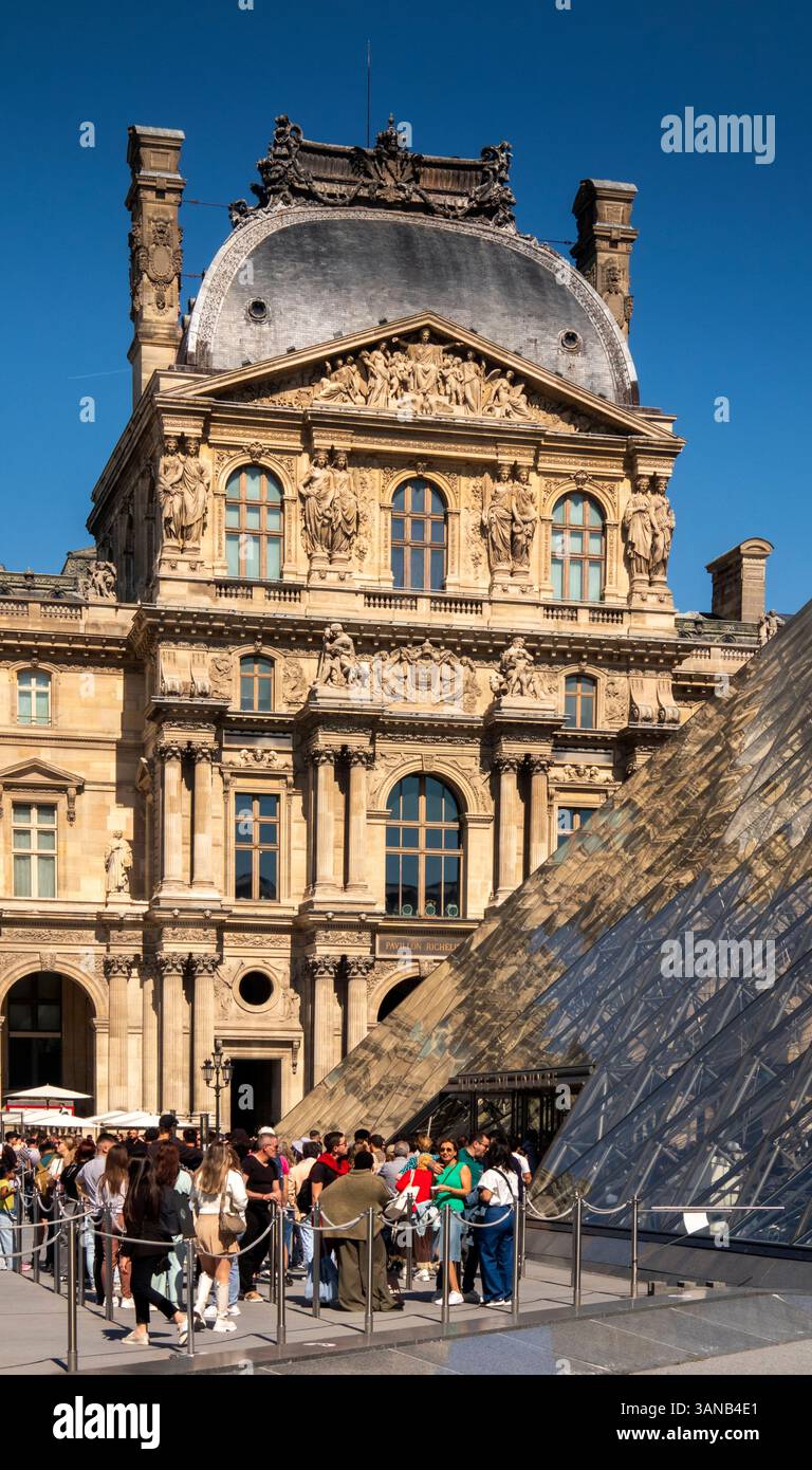 France, Paris, Louvre Museum, visitors queueing to enter at Pyramid ...