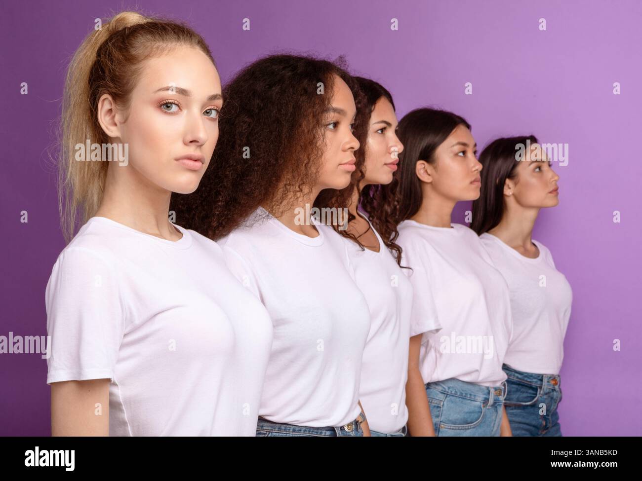 Group Of Serious Multicultural Women Standing In Row, Purple Background ...