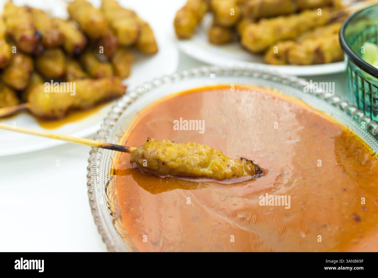 Pork satay with peanut sauce served with pickles which are cucumber ...