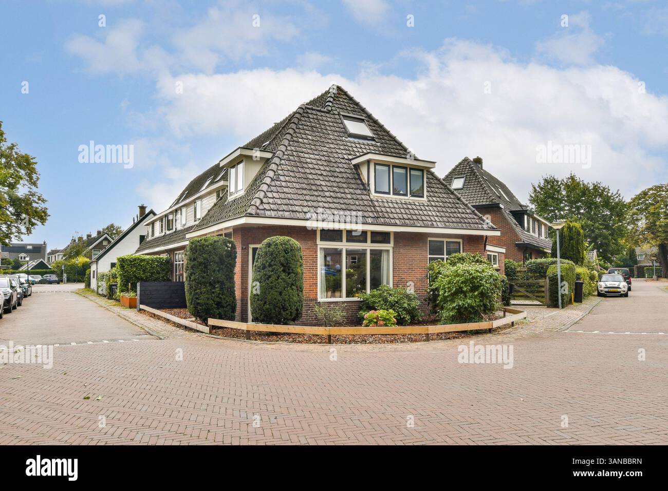 A picturesque house with a unique architectural design is surrounded by ...