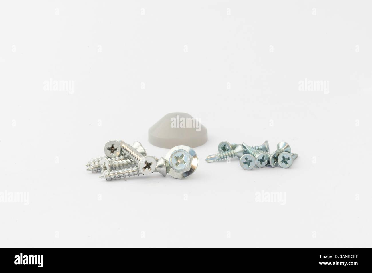 Screws of different sizes and accessories on white background Stock ...
