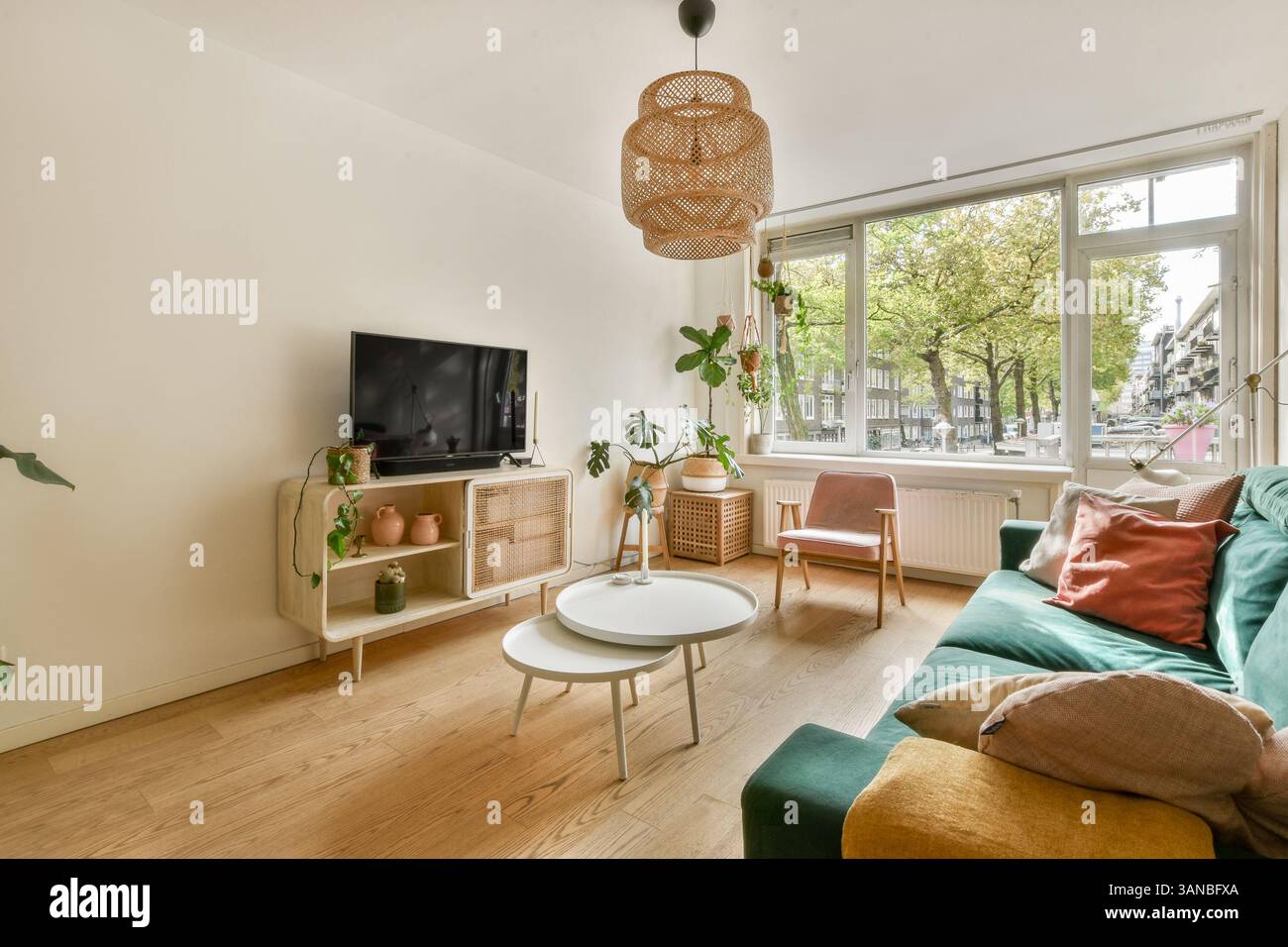 A stylish living room featuring a comfortable couch, TV setup, and ...