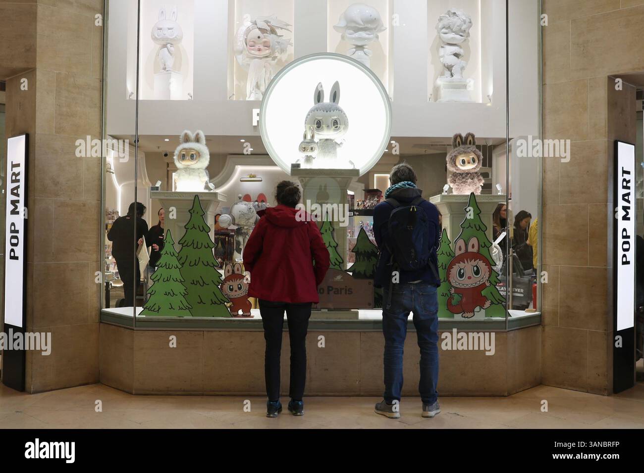 Paris, France. 18th Mar, 2025. People linger around a POP MART store, a ...