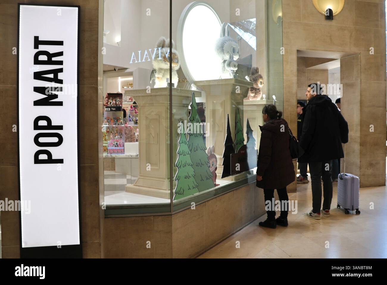 Paris, France. 18th Mar, 2025. People linger around a POP MART store, a ...