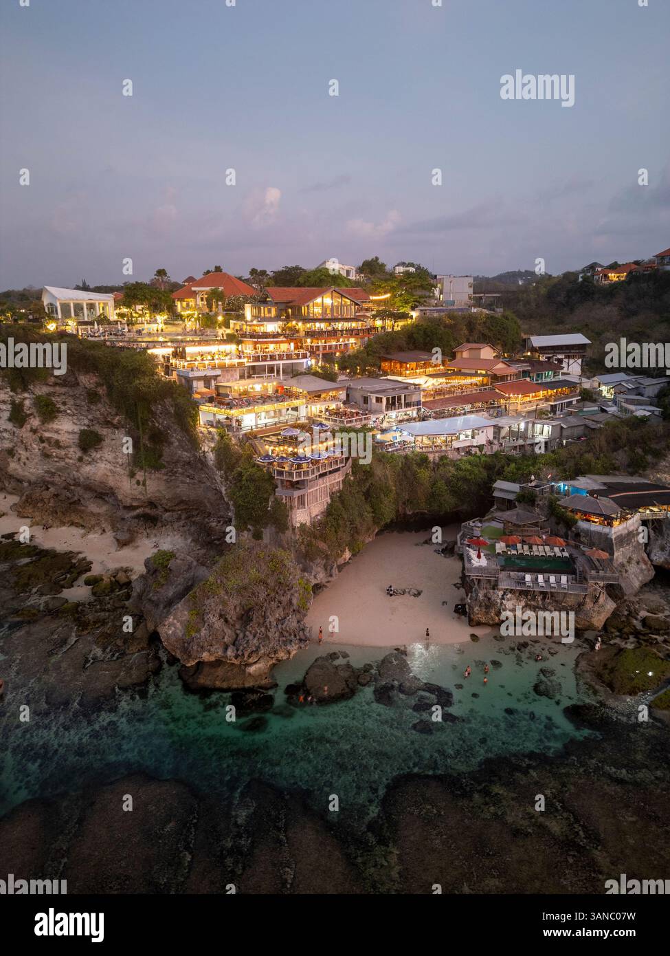 Aerial view of beautiful Uluwatu beach with cliffs and ocean waves at ...