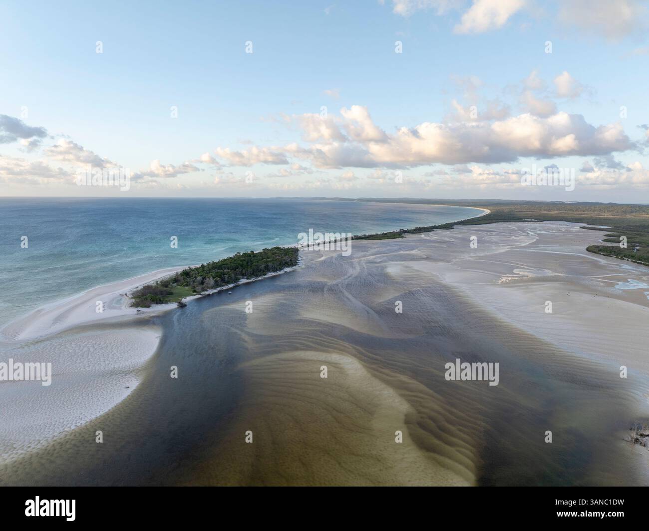Aerial view of pristine beach and serene coastline with lush forest and ...