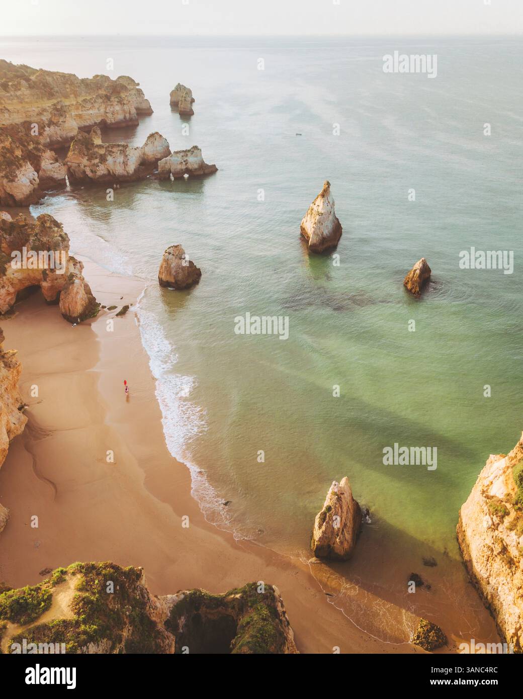 Aerial view of scenic Praia dos Tres Irmaos beach with tranquil waves ...