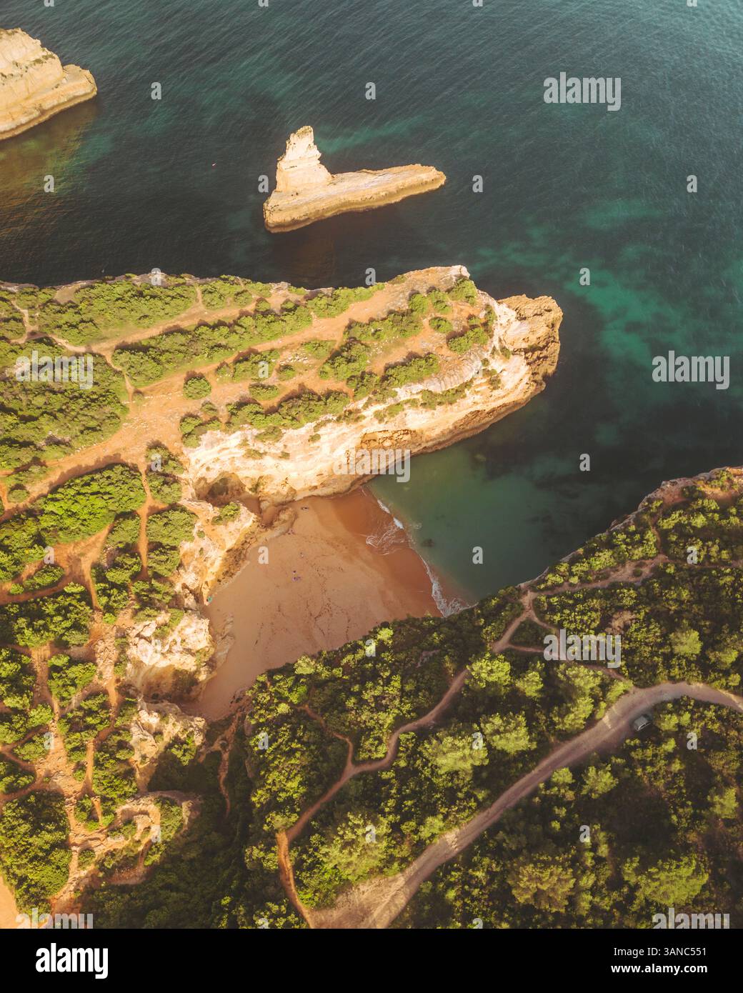 Aerial view of Praia da Morena with rugged cliffs and blue waters ...