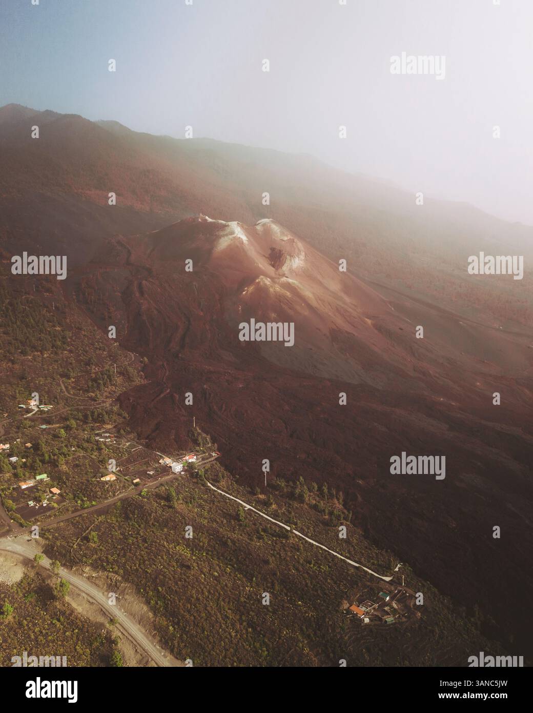 Aerial view of volcanic eruption landscape with lava flow and buried ...