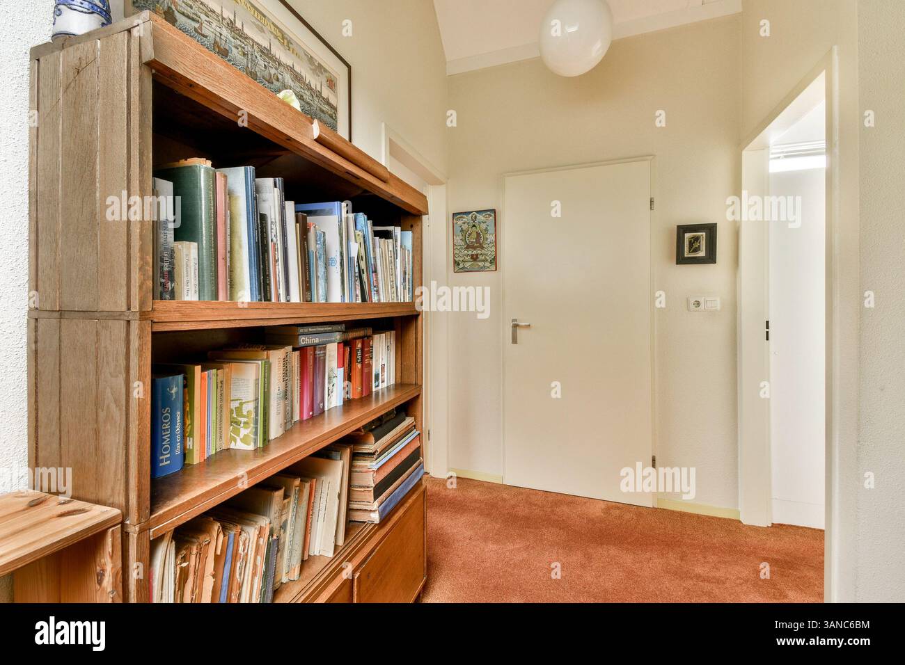 A charming interior featuring a wooden bookshelf filled with books, set ...