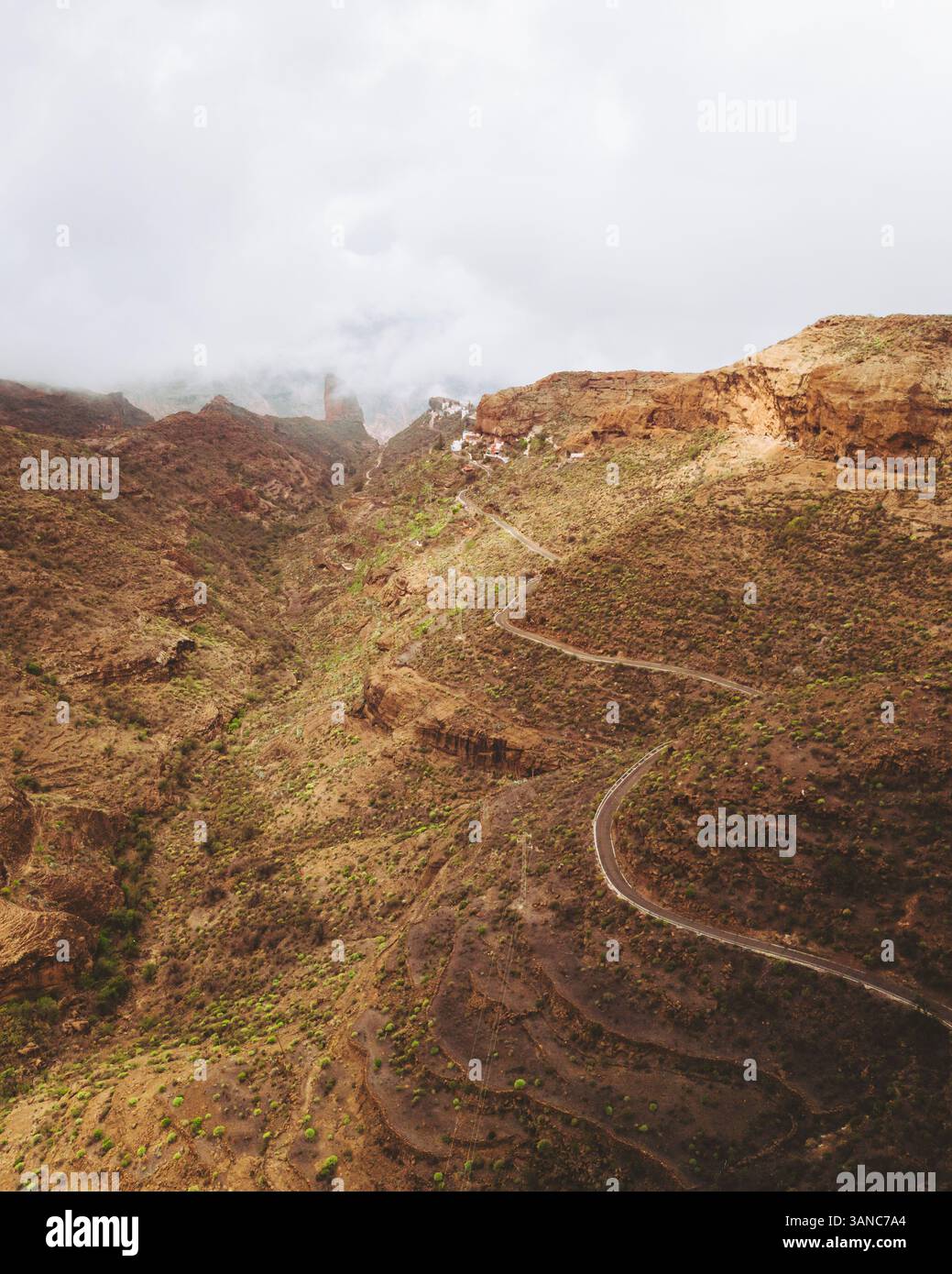 Aerial view of rugged mountains and winding road in a scenic valley ...