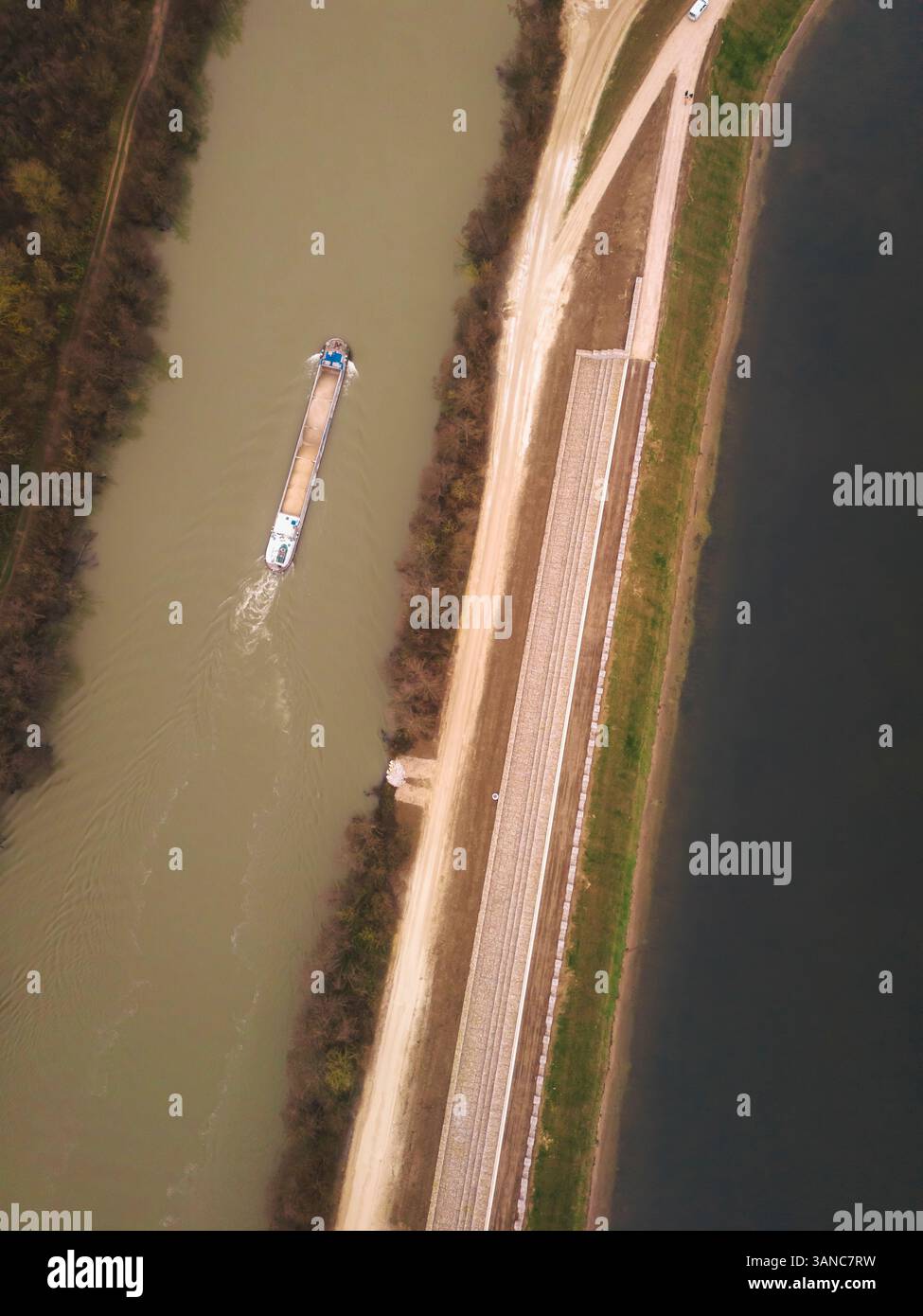 Aerial view of serene Seine River Retention Basin with barge and lush ...