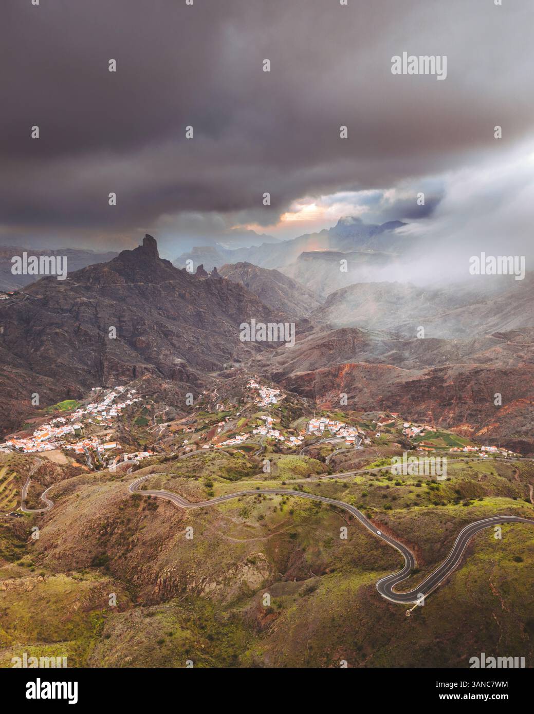 Aerial view of roque bentayga with picturesque village and winding road ...