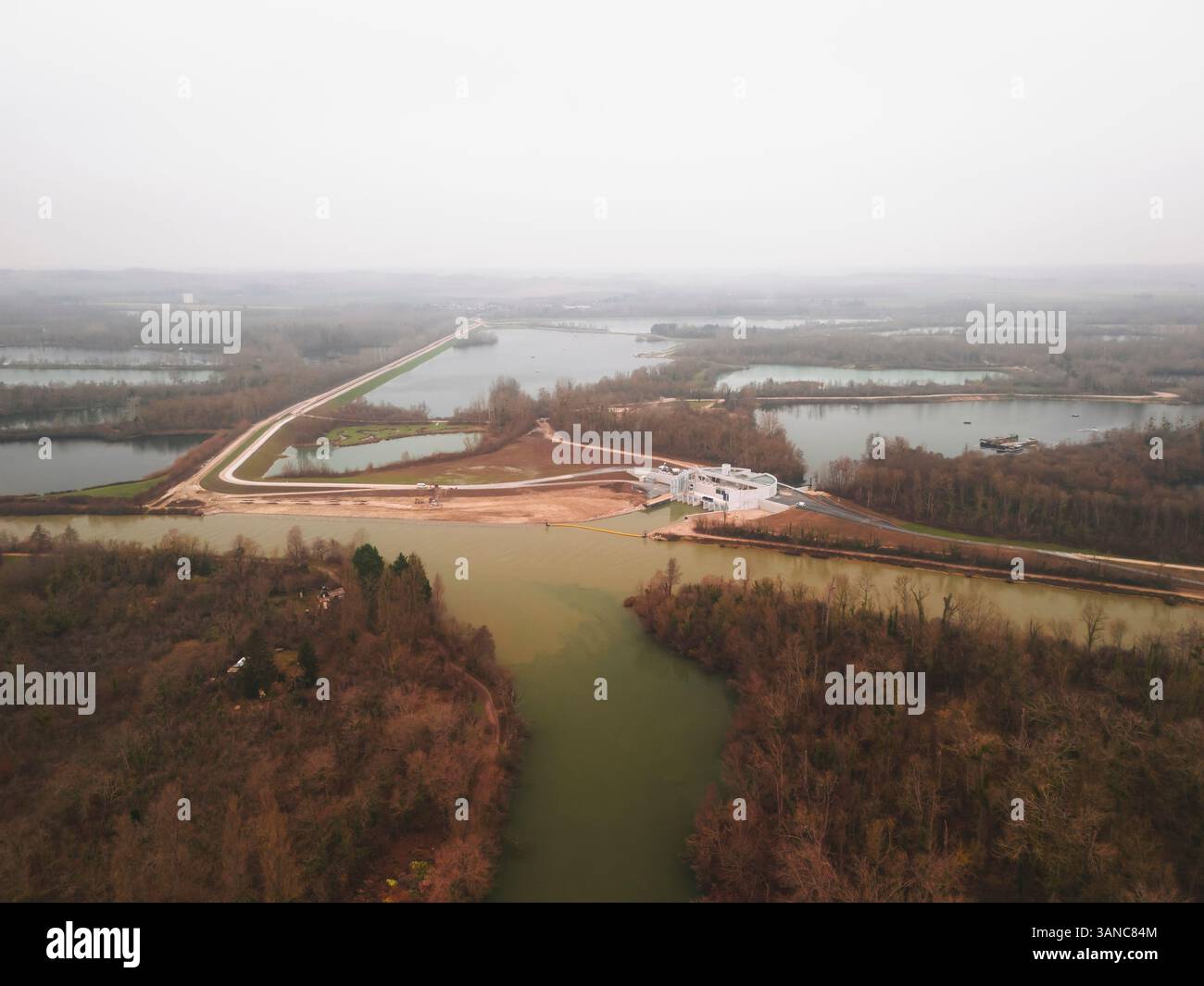 Aerial view of serene seine river retention basin with lush forests and ...