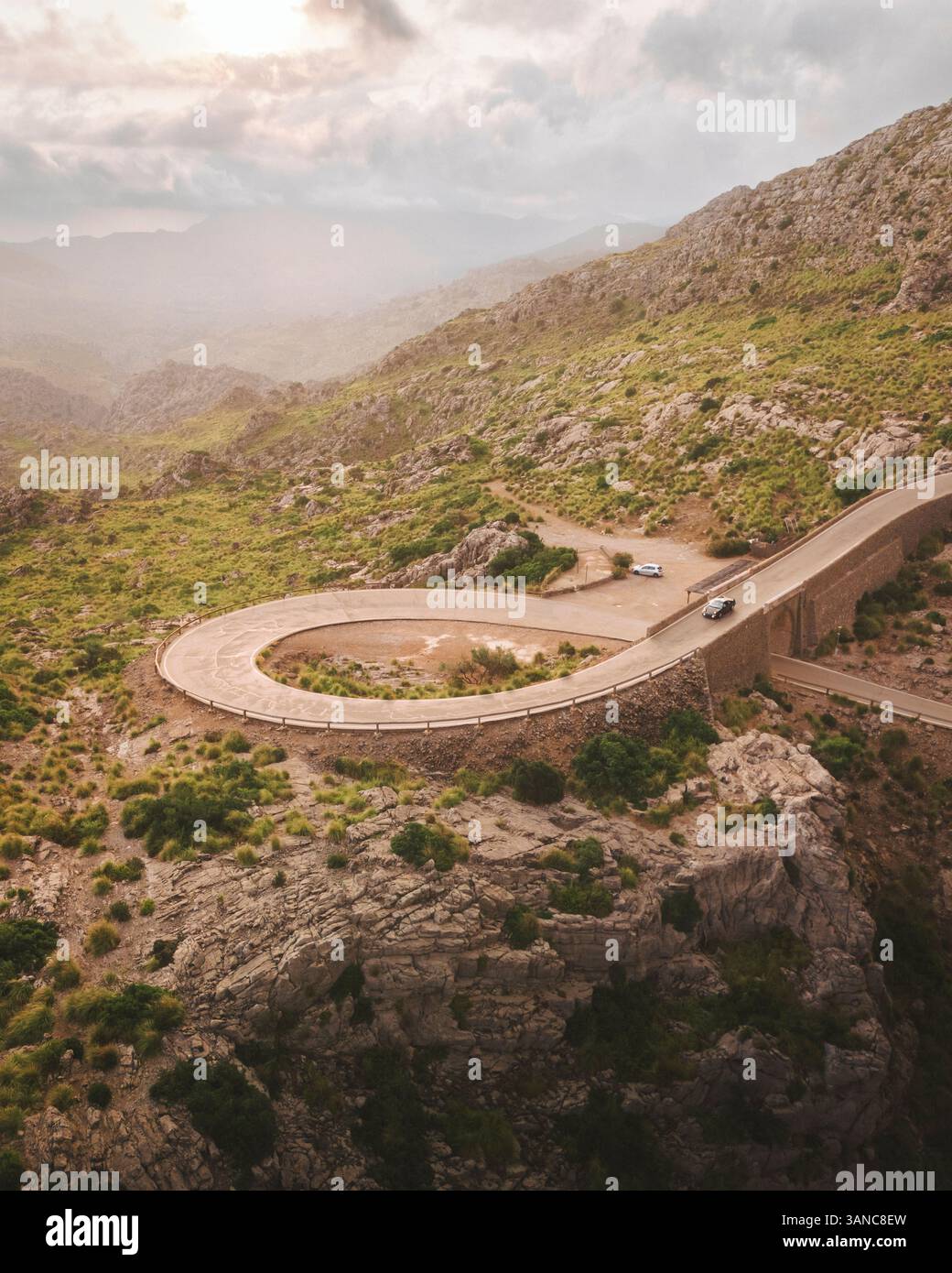 Aerial view of winding road through rugged mountains and picturesque ...