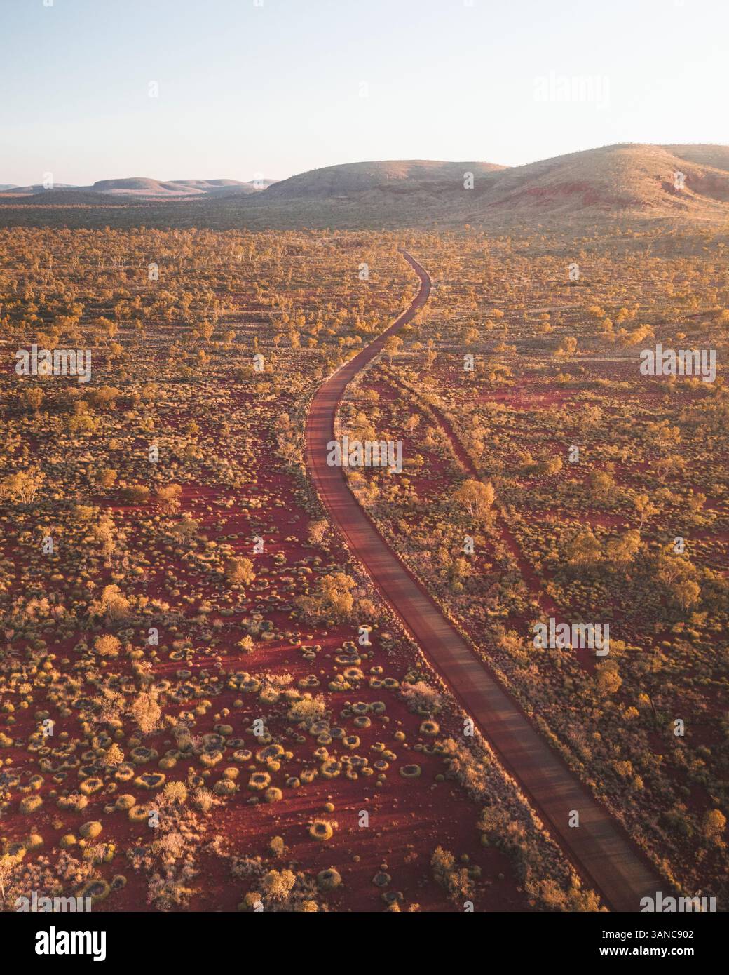 Aerial view of scenic desert landscape with winding road and sparse ...