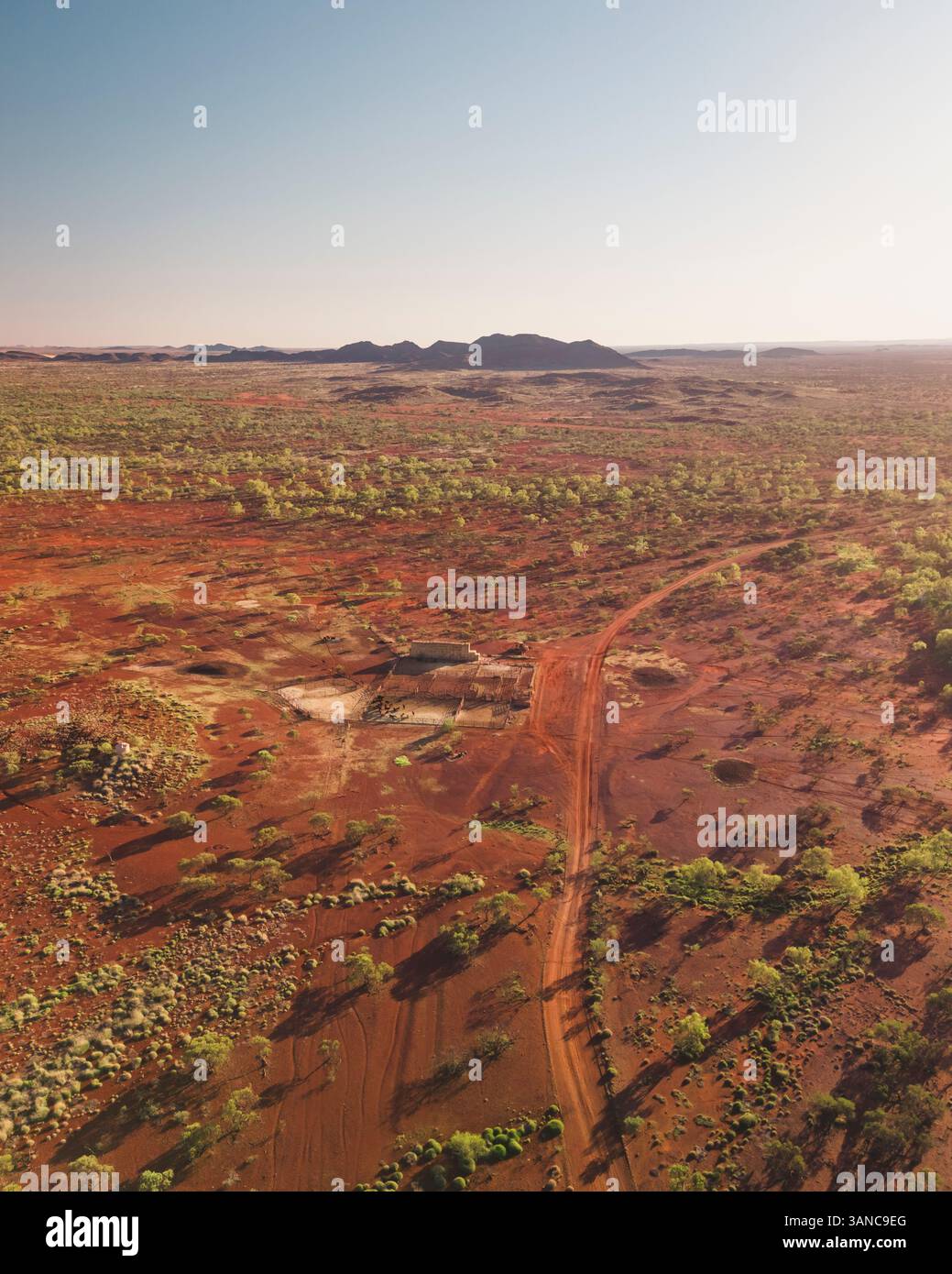 Aerial view of expansive arid landscape with red earth and sandy dunes ...