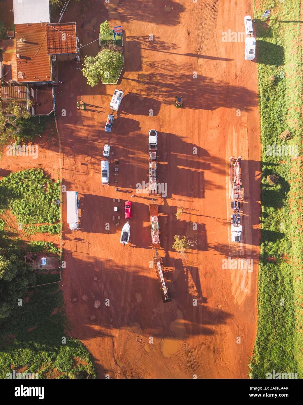 Aerial view of minilya camping site with vehicles and roadtrain amidst ...