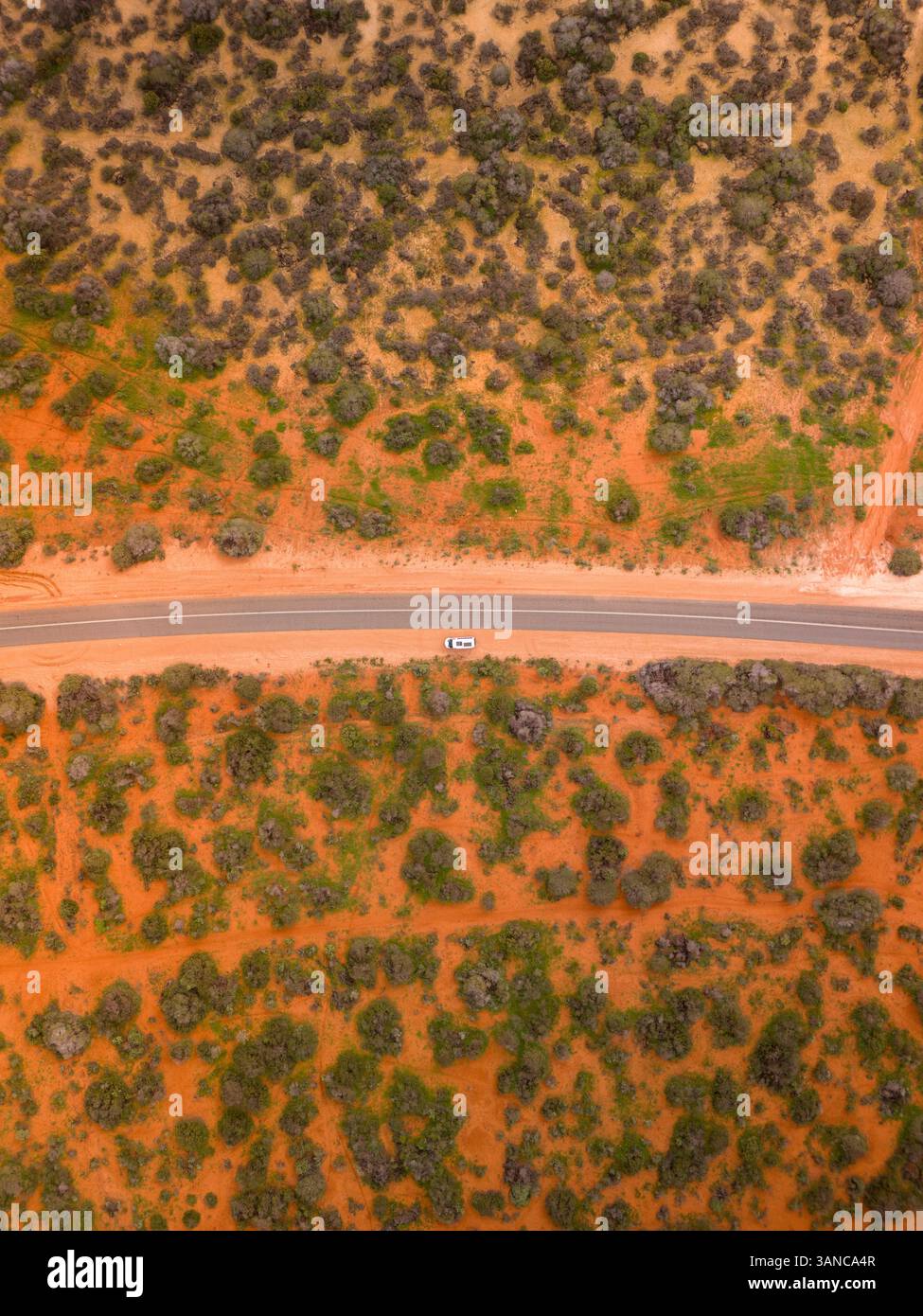 Aerial view of scenic desert landscape with road and car in remote ...