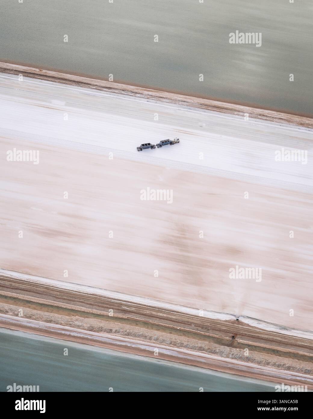 Aerial view of barren salt marshes with a road and vehicle, Useless ...