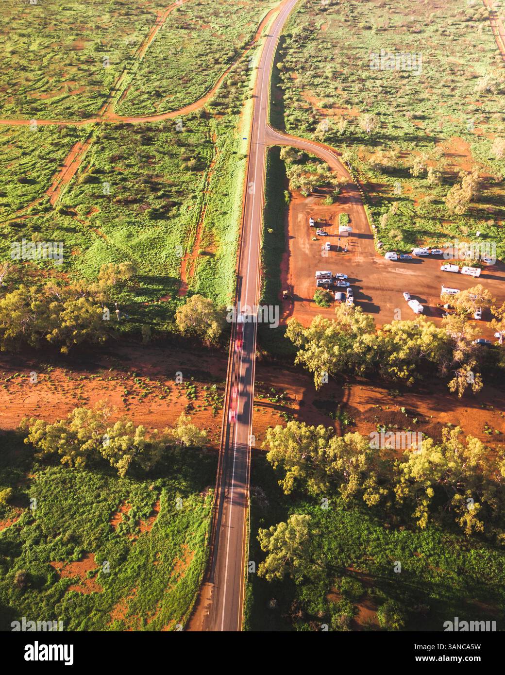 Aerial view of winding road through lush greenery and trees in the ...