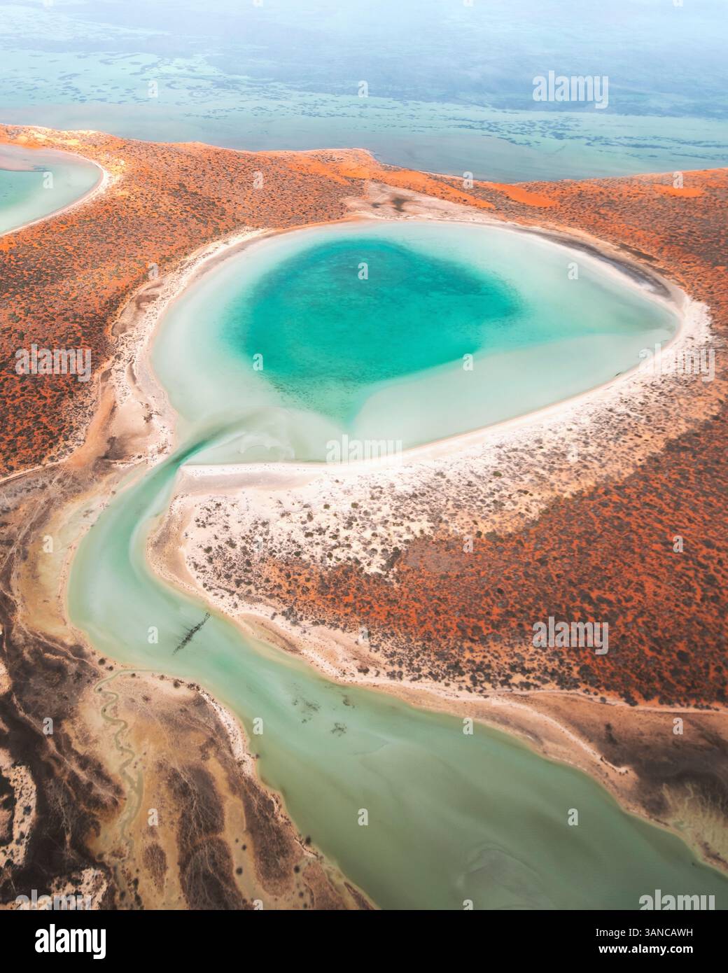 Aerial view of big lagoon with turquoise water and red earth coastline ...