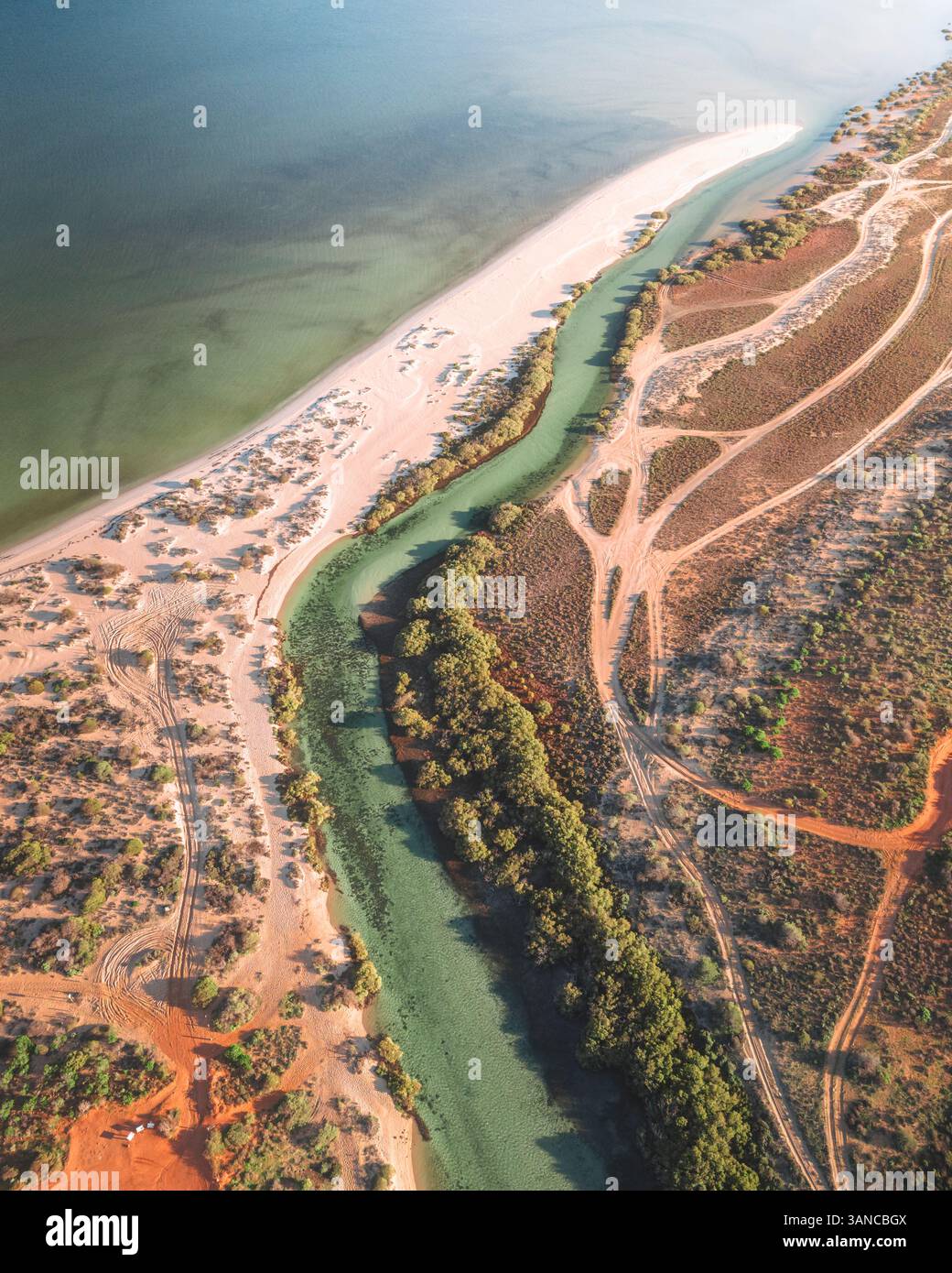 Aerial view of little lagoon creek with pristine coastline and tranquil ...