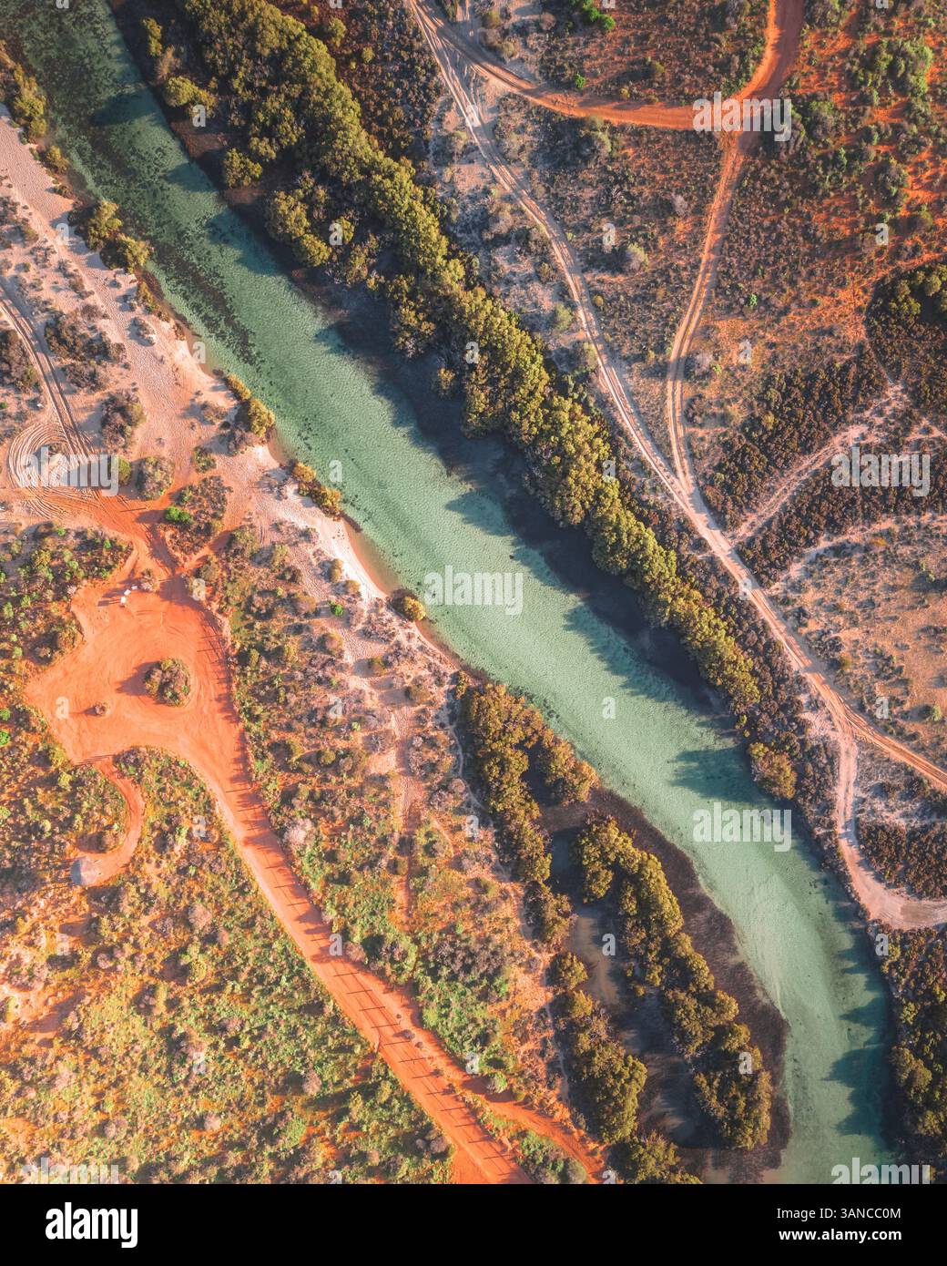 Aerial view of serene Little Lagoon Creek surrounded by lush green ...