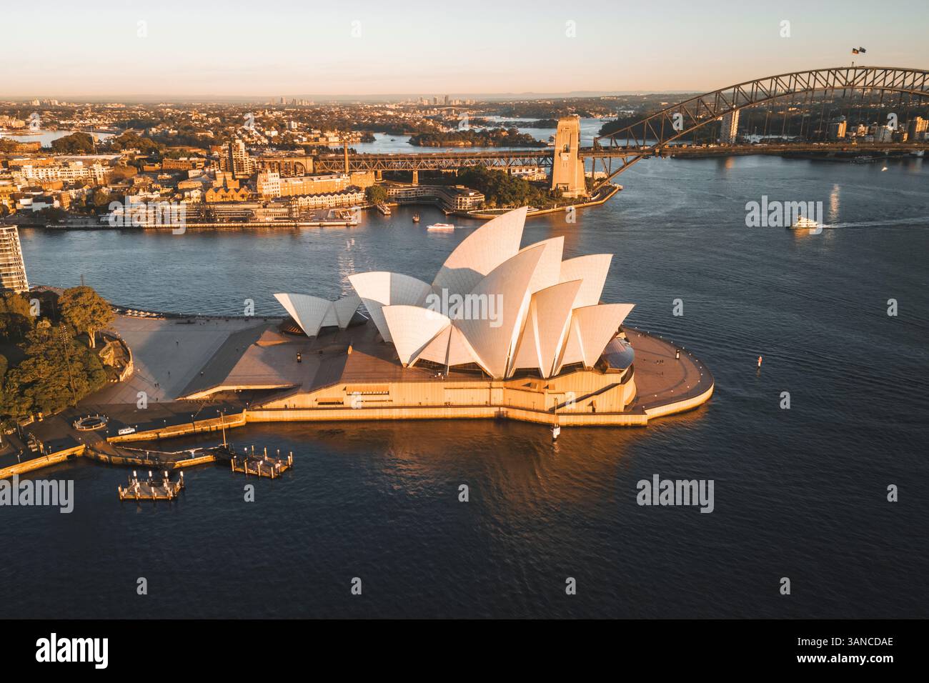 Aerial view of sydney opera house and harbour bridge at sunrise, sydney ...