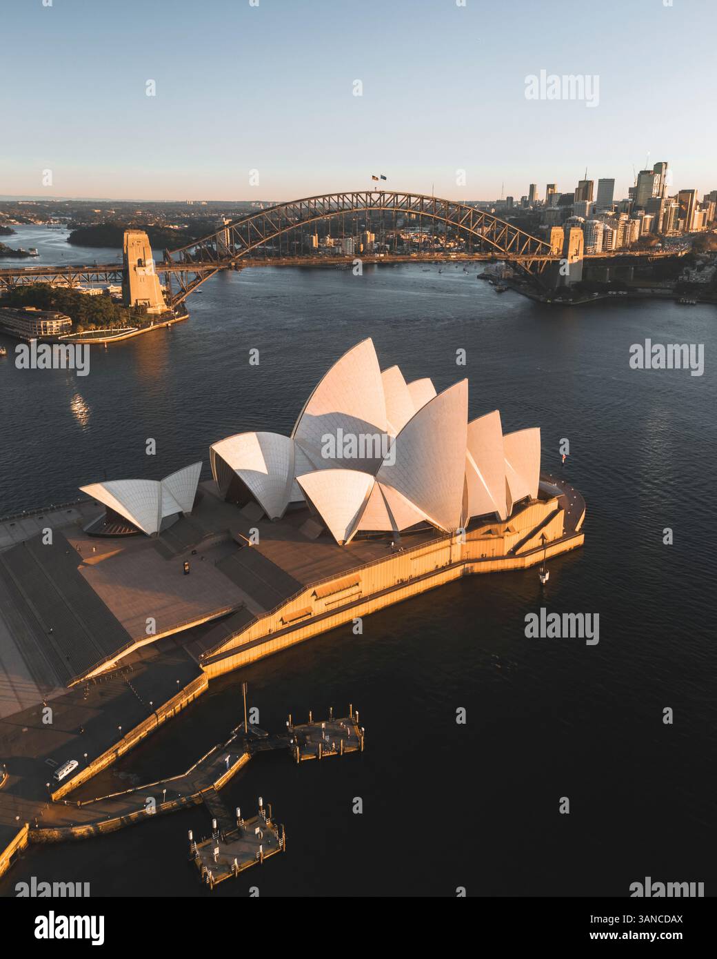 Aerial view of sydney opera house and harbour bridge at sunrise with beautiful cityscape and ...