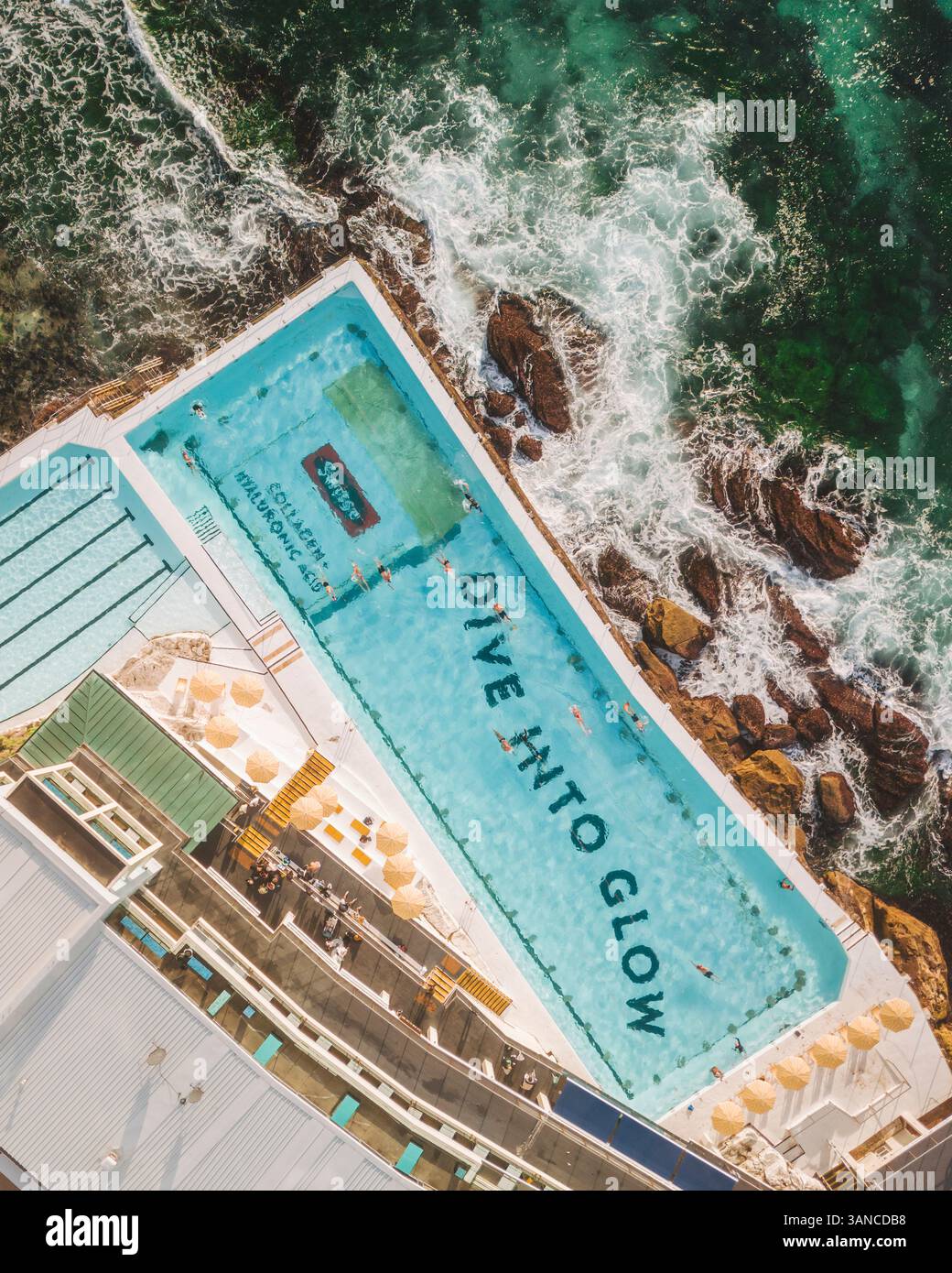 Aerial view of bondi icebergs swimming club with ocean waves and rocky ...