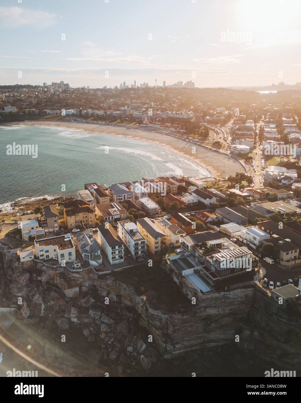 Aerial view of beautiful Bondi Beach with cliffs and urban cityscape at ...