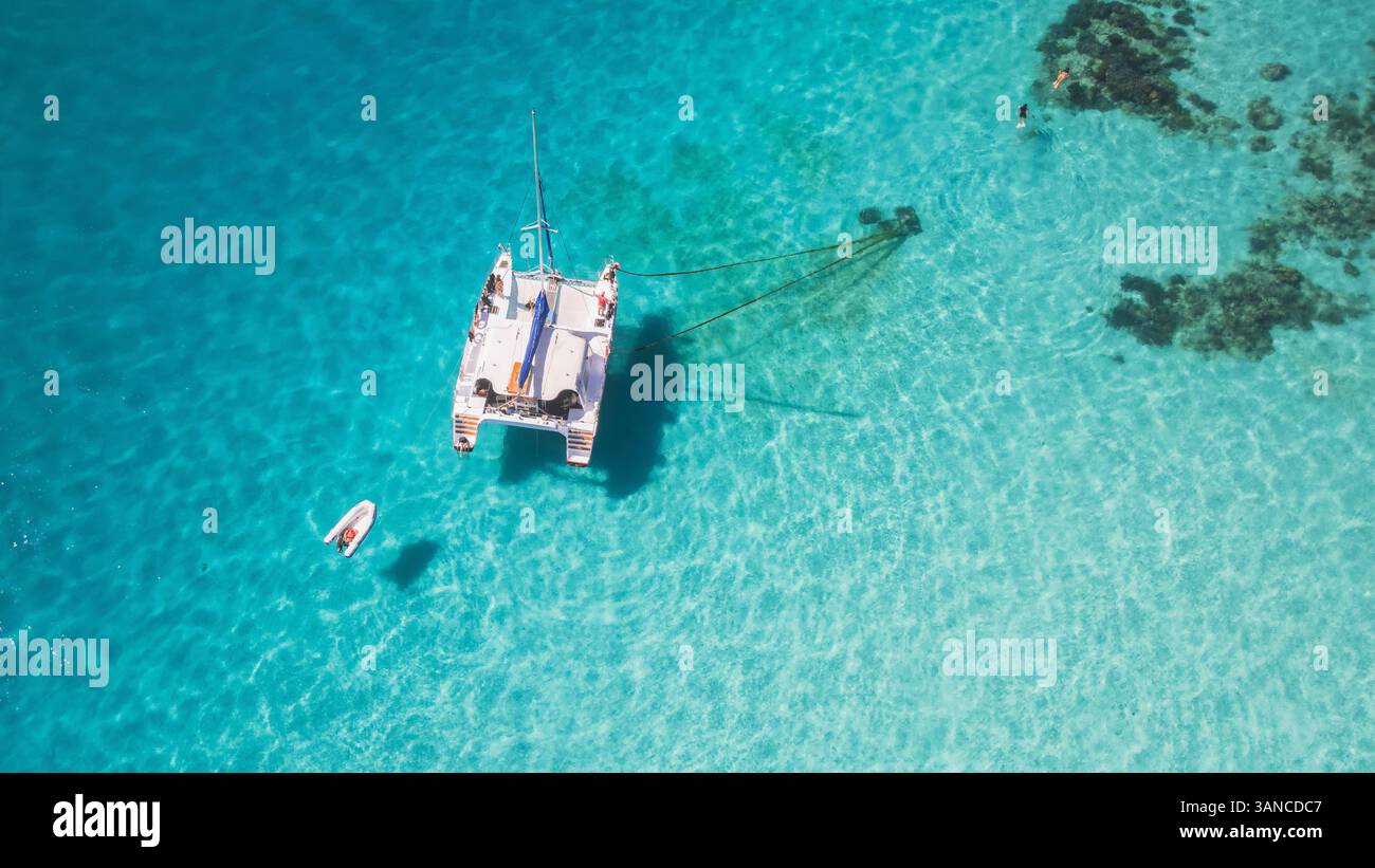 Aerial view of a sailboat on the turquoise ocean over the Great Barrier ...
