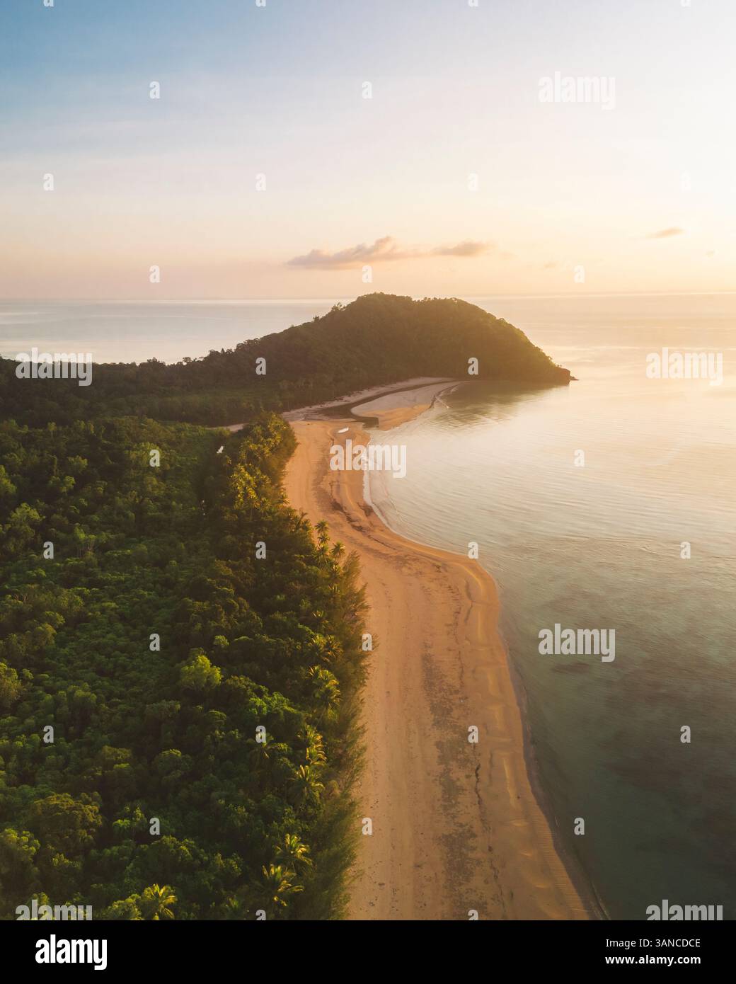 Aerial view of serene Myall Beach bordered by lush Daintree Rainforest ...
