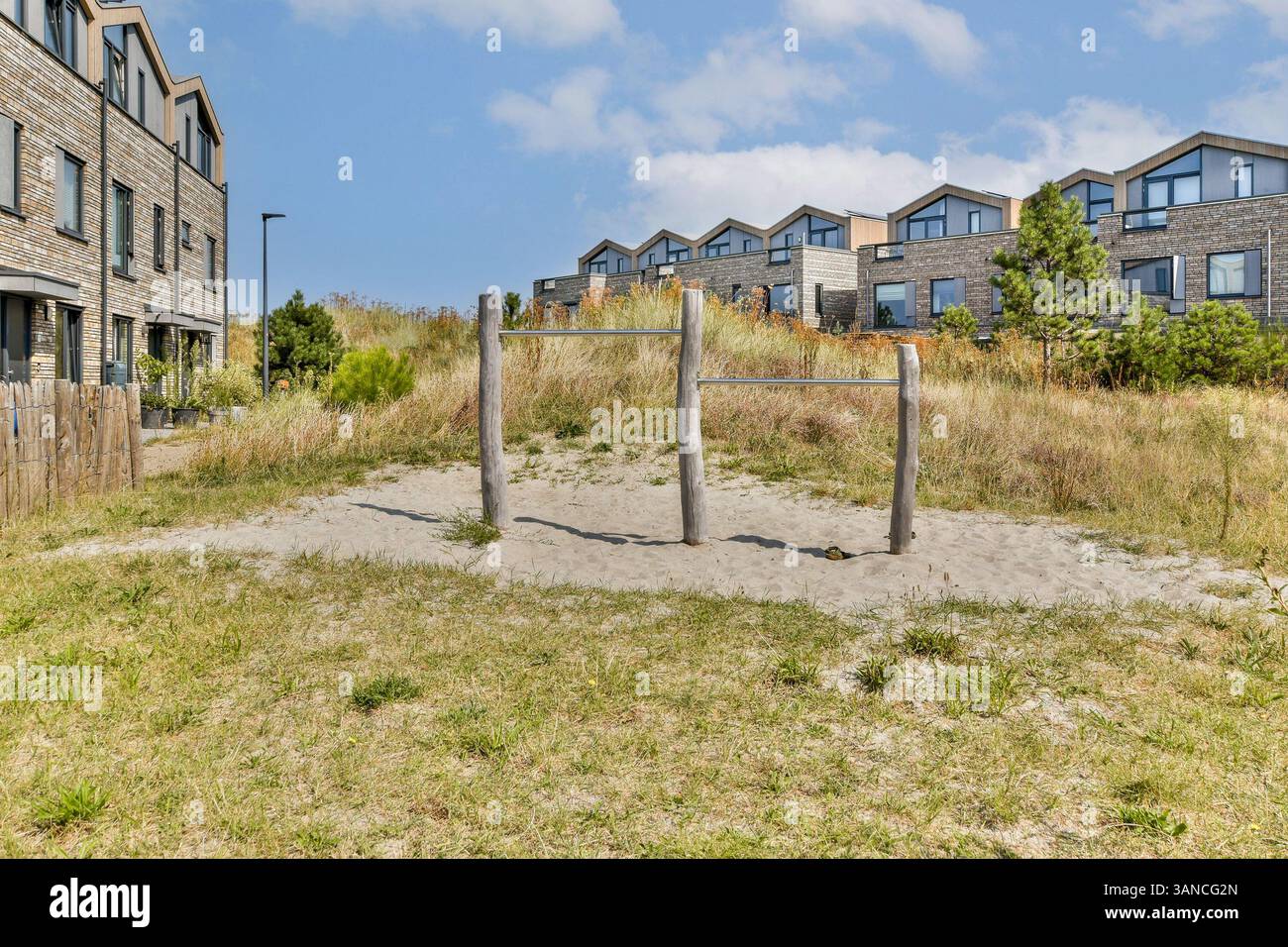 A spacious playground featuring wooden equipment set against a backdrop ...